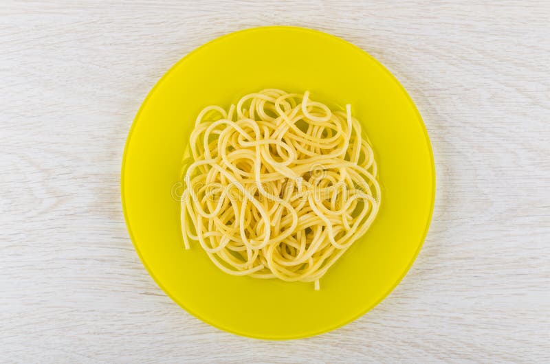 Spaghetti in Yellow Plate on Wooden Table Stock Photo - Image of ...