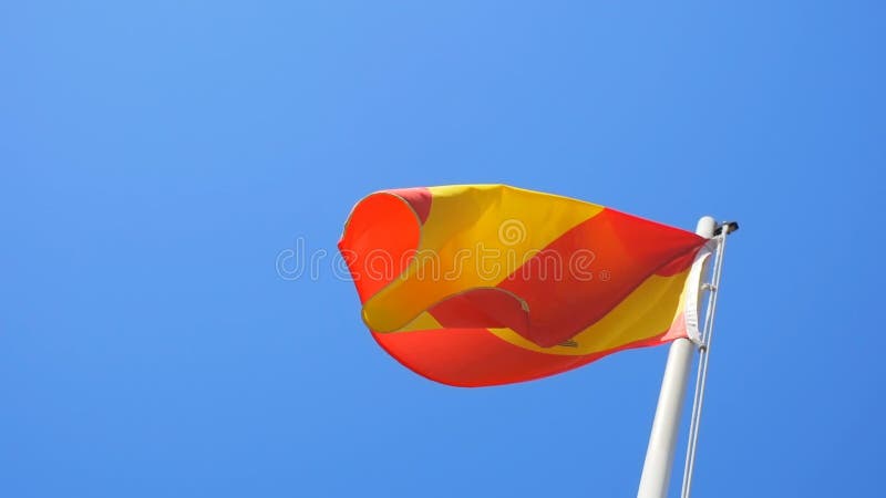 Spanish Flag Flying in the Blue Sky Background Stock Footage - Video of ...