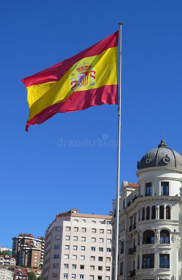 Spanish Flag Flying Over the City, Under a Clear Blue Sky Stock Image ...