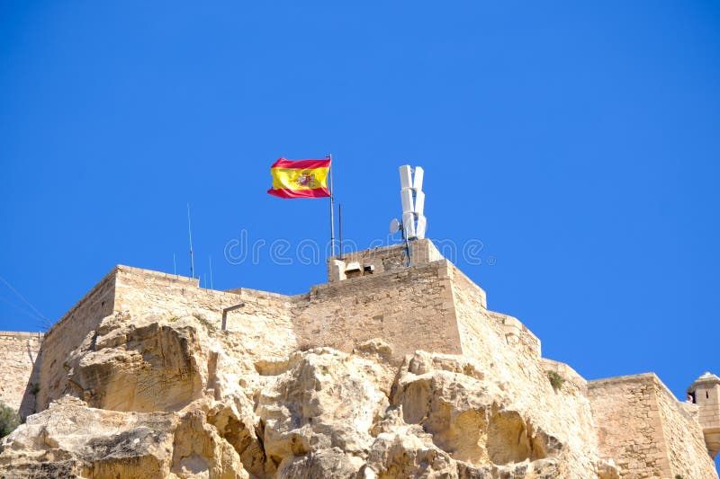 Spanish Flag Waves on Historic Castle Against Clear Blue Sky Stock ...