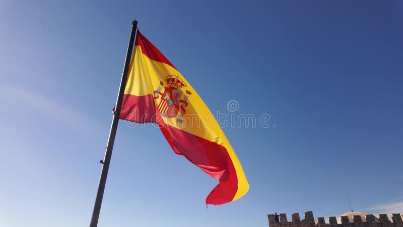 Spanish Flag Waving in the Wind in Slow Motion with the Sun Shining in ...