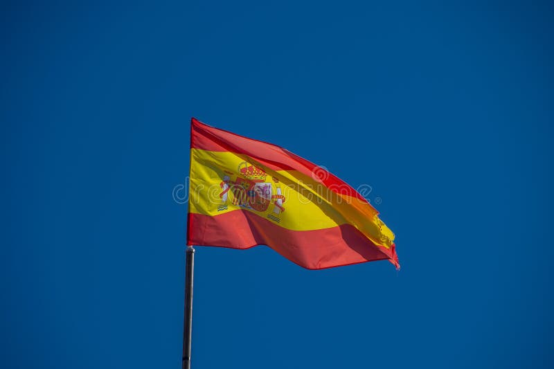 The Spanish National Flag Flies on a Flagpole Stock Image - Image of ...