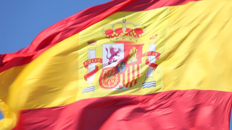 Spanish National Flag Waving on a Flagpole Against a Clear Sky Stock ...