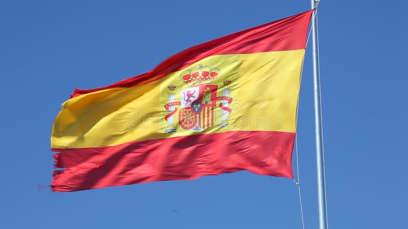Spanish National Flag Waving on a Flagpole Against a Clear Sky Stock ...