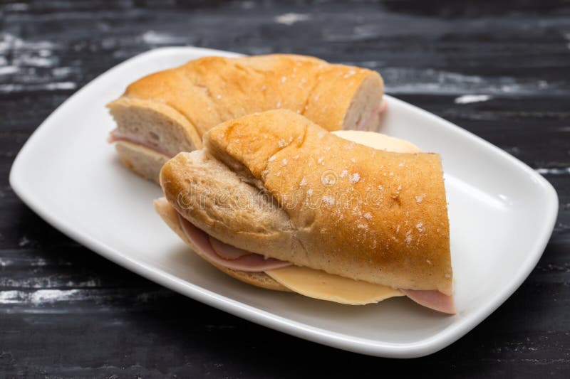 A Spanish Rosca De Jamon Serrano, Ham Sandwich, on a White Plate Stock ...
