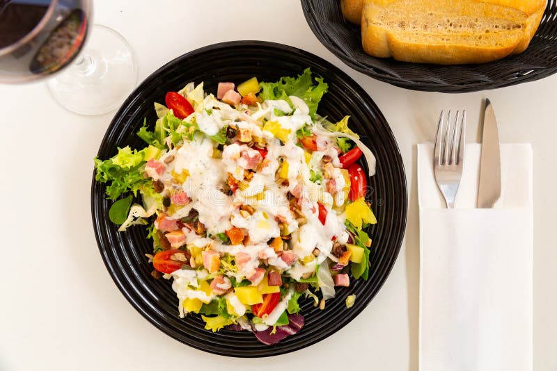 Spanish Lettuce Salad with Sauce and Bacon in Black Plate for Dinner ...