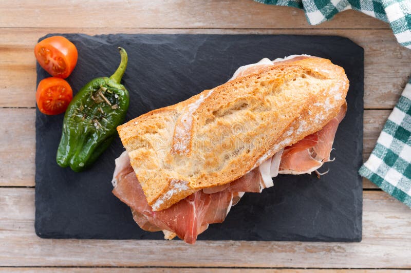 Spanish Serrano Ham Sandwich on Wooden Table. Spanish Bocadillo De ...