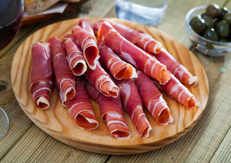 Spanish Tapas - Rolls of Jamon Serrano Served on Wooden Board Stock ...