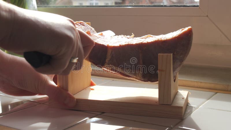 Spanish Traditional Pork Jamon. a Knife Cuts a Piece of Hamon Meat into ...