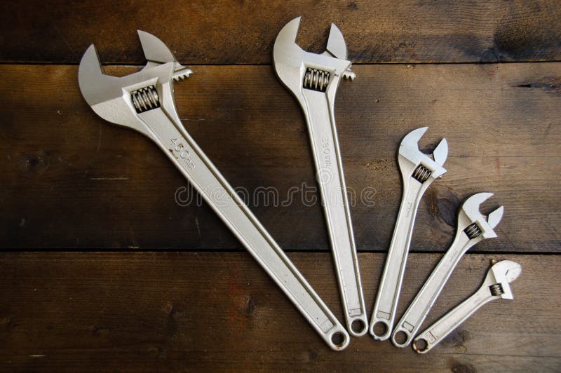 Spanner or Adjustable Wrench on Wooden Back Ground, Basic Hand Tools ...