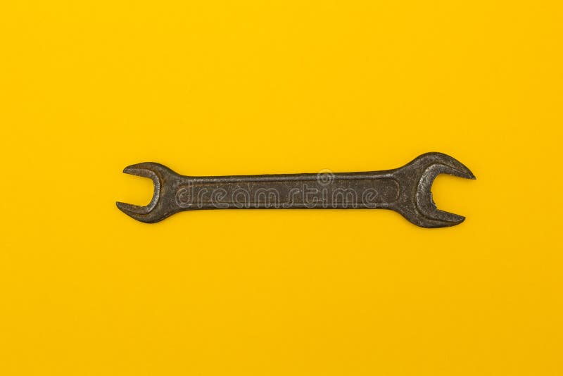 Spanner on a Yellow Background Stock Photo - Image of fitter ...