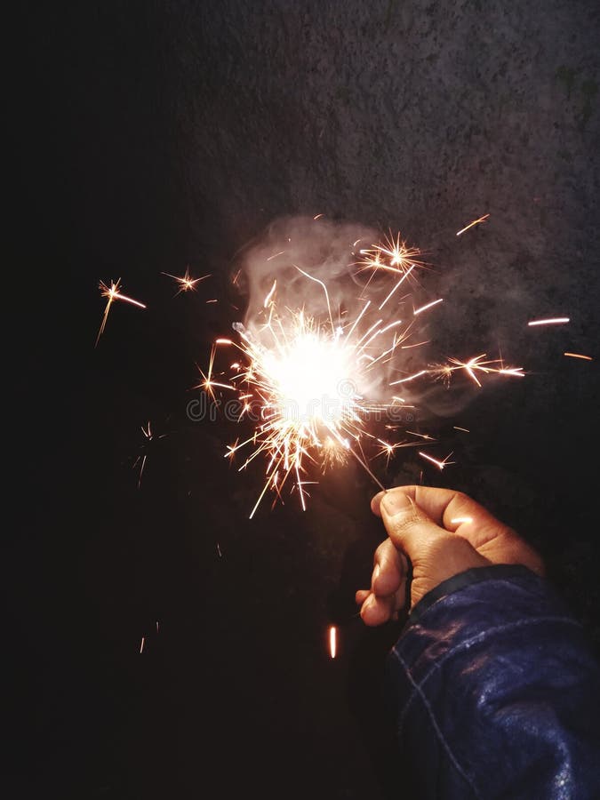 A Spark Crackers in Manâ€™s Hand Stock Photo - Image of light, crackers ...