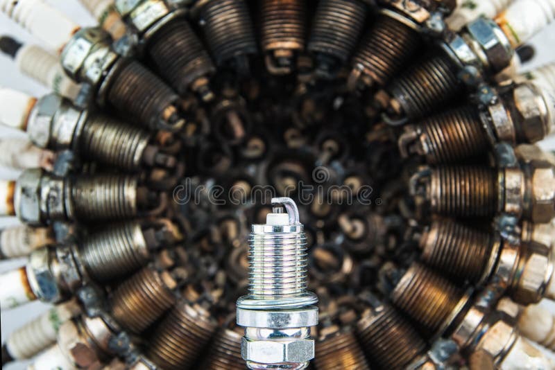 Spark Plug on a Background of Used Spark Plugs Arranged in a Circle ...
