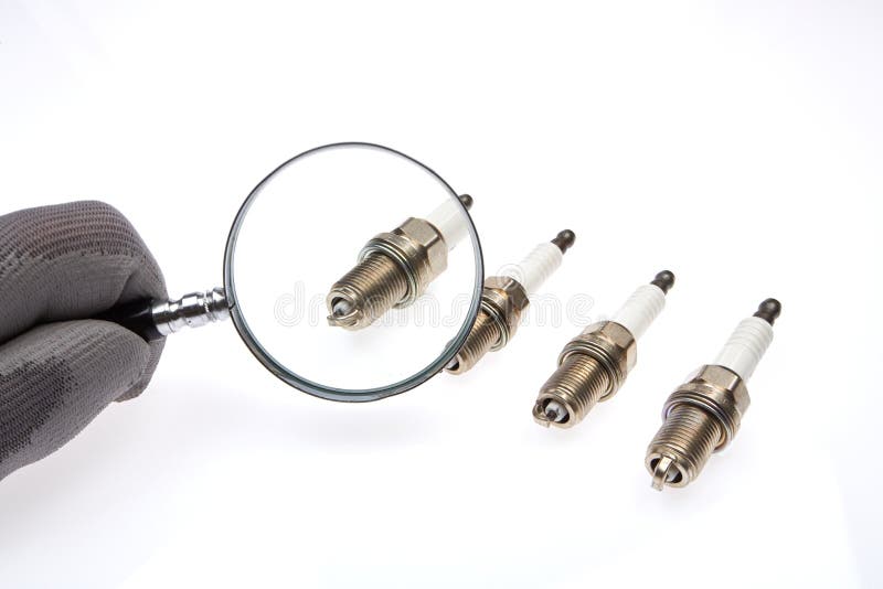 4 Spark Plugs with a Magnifying Glass Stock Image - Image of assembly ...