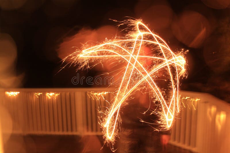 Sparkler forming a star stock image. Image of forming - 139583721