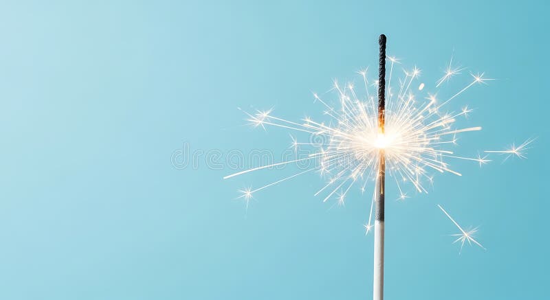 Sparkler Igniting with Bright White Sparks Against a Soft Blue ...