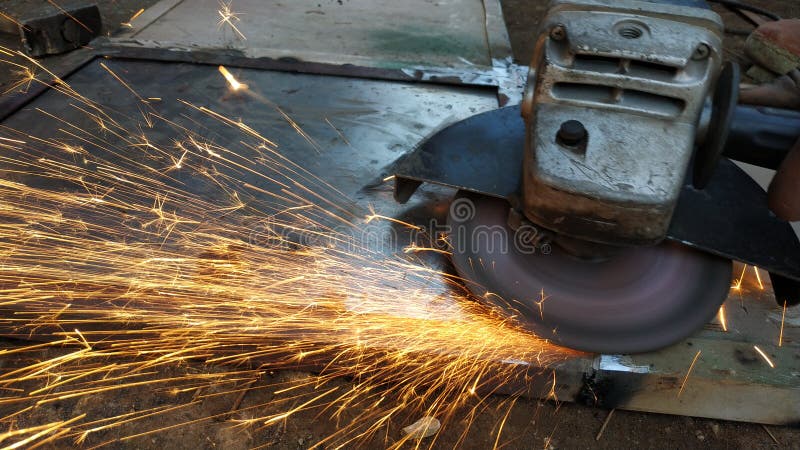 An Iron Worker Doing Grinder Work Stock Image - Image of sparkles ...
