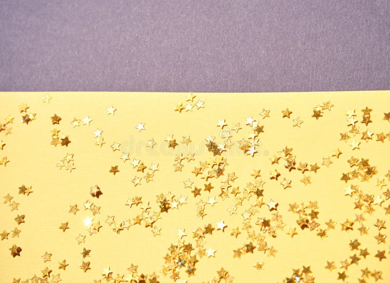 Sparkling Gold Star Confetti Scattered on Yellow Paper Background with ...