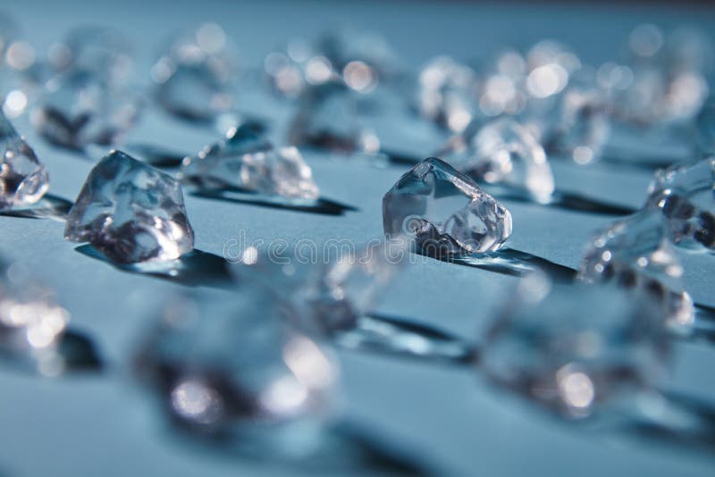 Sparkling Ice Cubes on a Blue Paper Background. Blurred Background ...