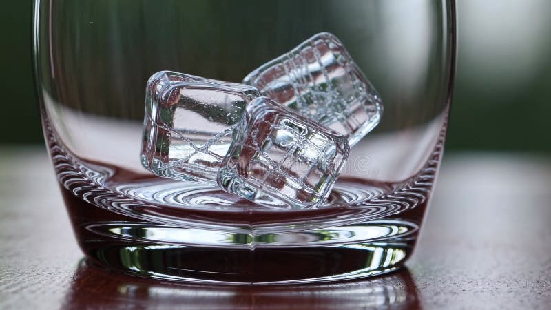 Sparkling Ice Cubes Splashing into Refreshing Liquid, Generating ...