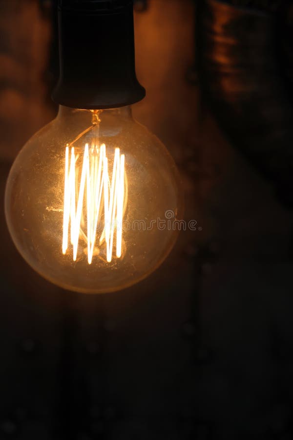 Sparkling Light Bulb on Black Background with Ample Copy Space. Stock ...