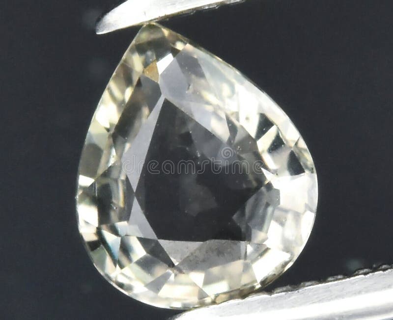 A Sparkling Pear-Shaped Diamond Gleaming Against a Dark Background ... A Sparkling Pear-Shaped Diamond Gleaming Against a Dark Background ...