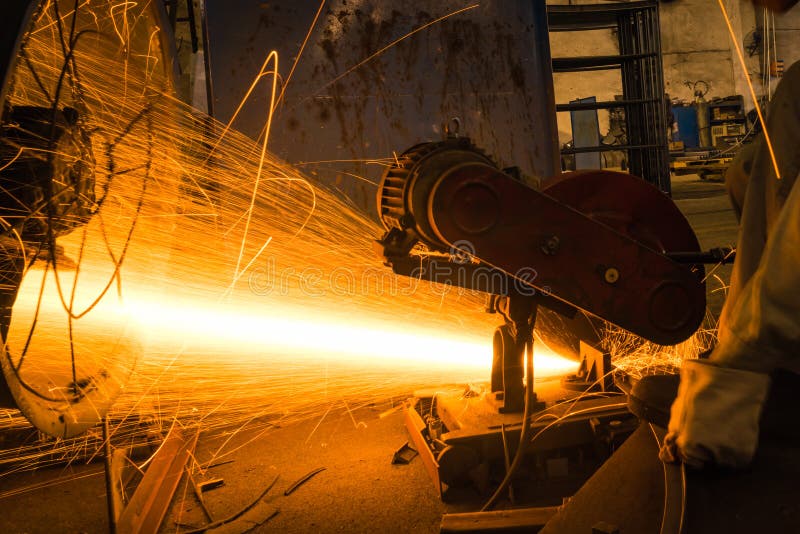 Sparks while grinding iron, The workers in the machinery factory made a ...