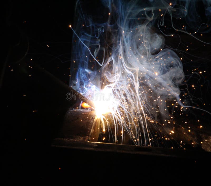 Sparks and Jets of Smoke when Welding Stock Photo - Image of equipment ...