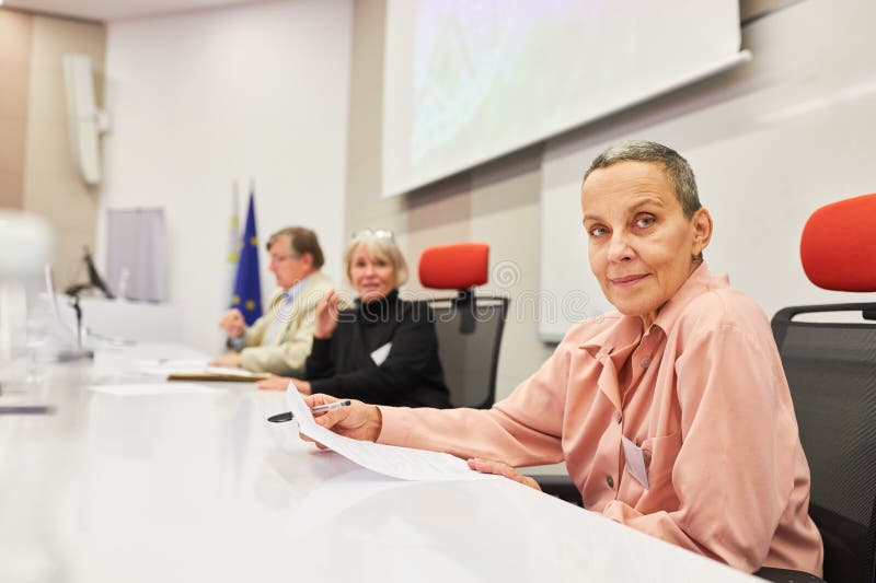 Speaker with Document at Table in Business Conference Stock Image ...
