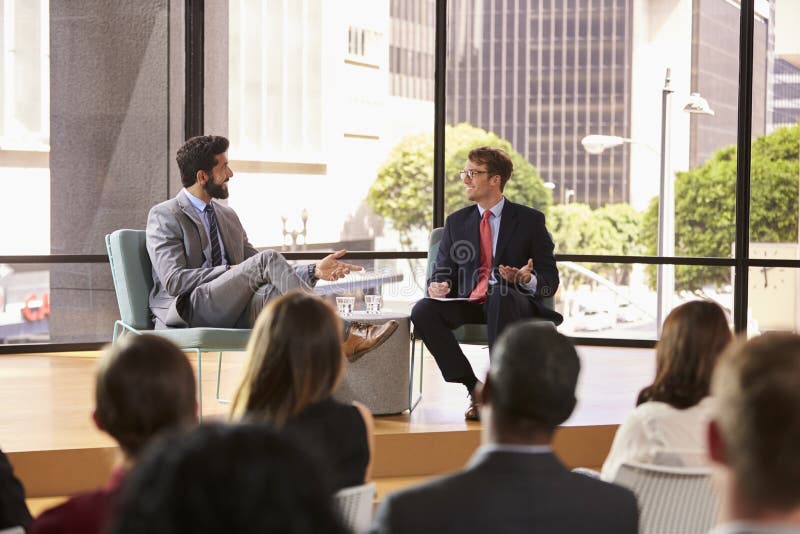 Speaker and Interviewer Talk in Front of Audience at Seminar Stock ...