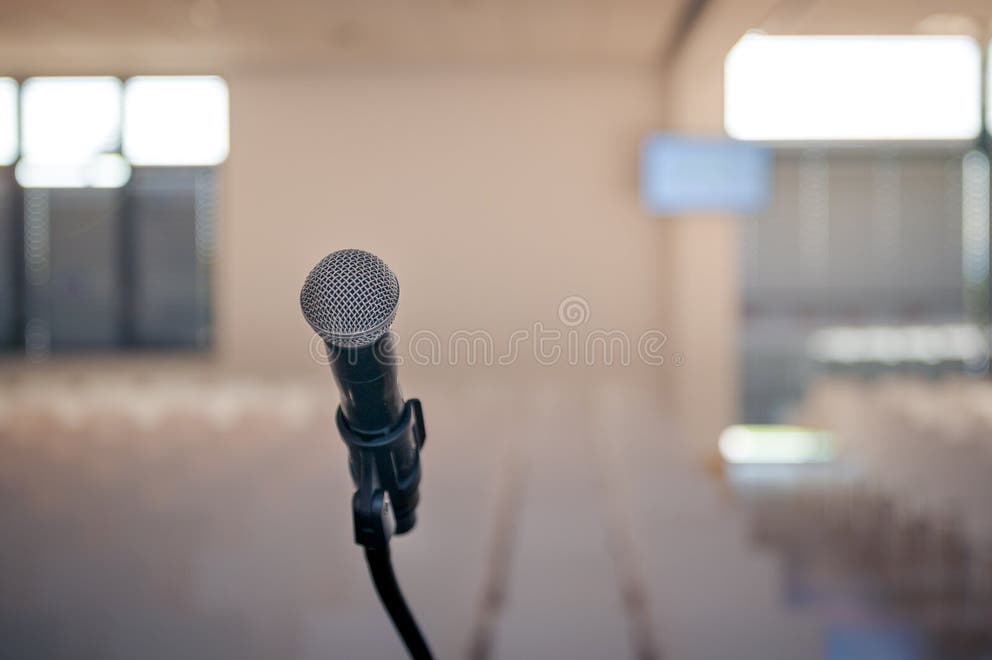 Speaker Microphone in Blurred Empty Conference Room with White Chairs ...