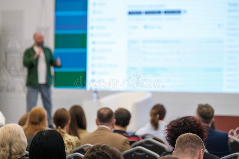 Speaker Presenting during Seminar with Audience at Conference Hall ...