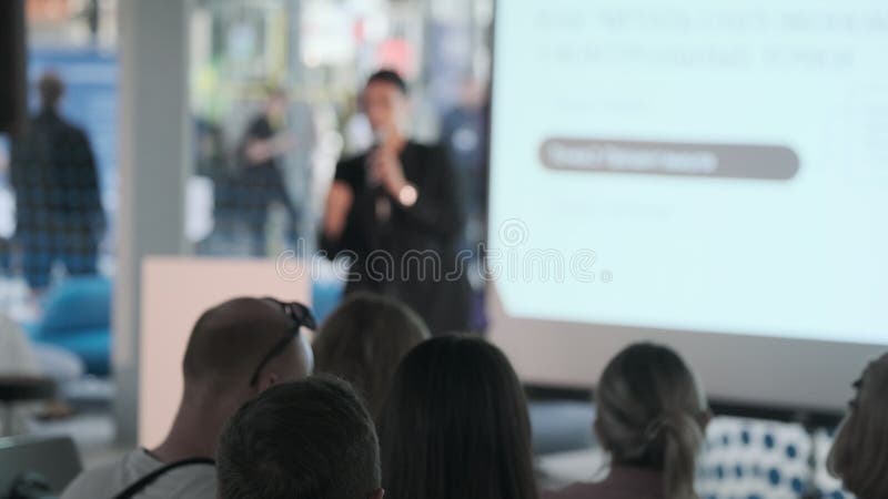 Speaker Presenting at a Conference in Front of Engaged Audience Stock ...