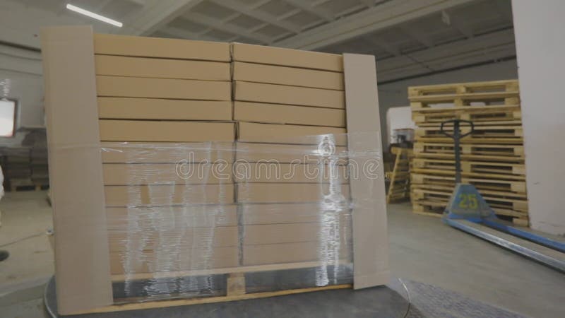 A Special Machine Wraps Boxes in Polyethylene Film. Packaging Boxes ...