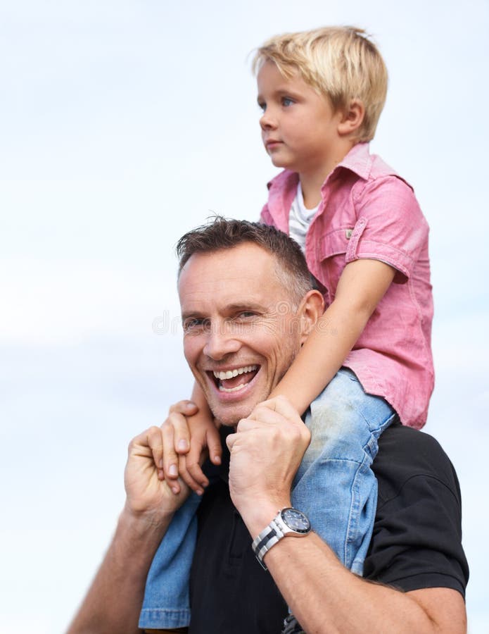 Special Moments With Dad A Handsome Father Carrying His Son On His