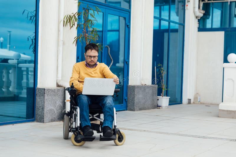 A Special Person with Disabilities with a Laptop Talking on the Phone ...