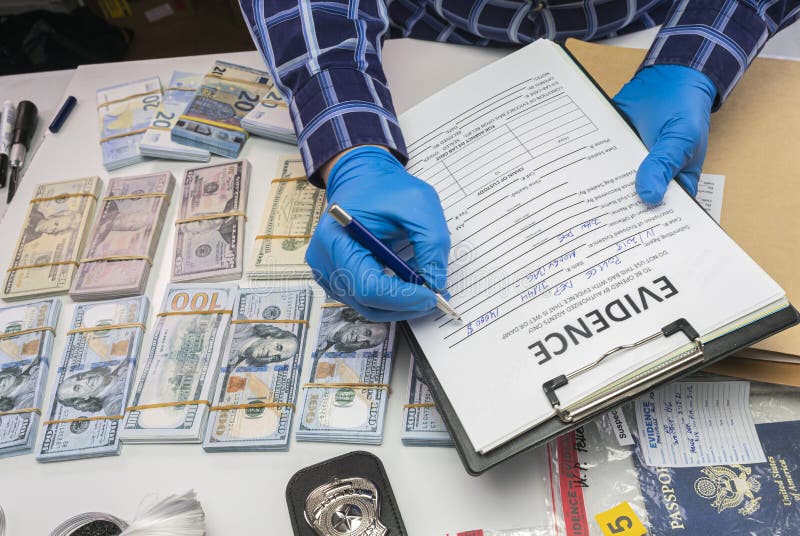 Specialised Police Officer Notes Dollar Banknote Reference of a Robbery ...
