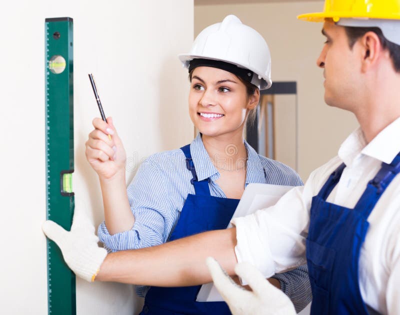 Specialist and Assistant Working with Wall in New Building Stock Photo ...