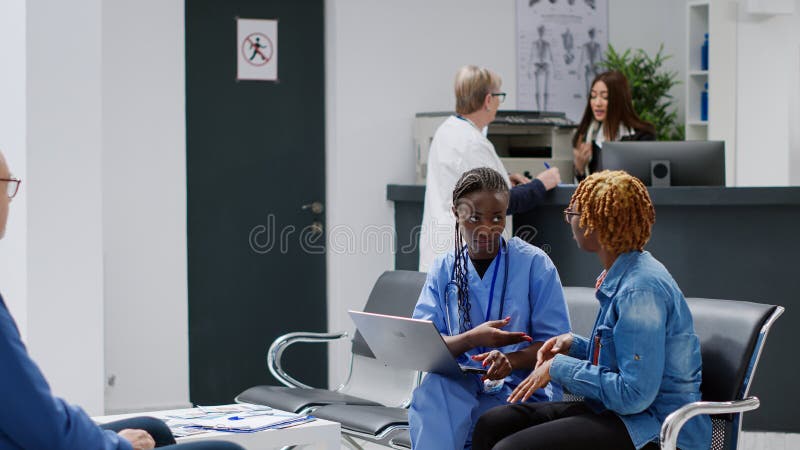 Specialist Consulting African American Patient in Waiting Room ... Specialist Consulting African American Patient in Waiting Room ...