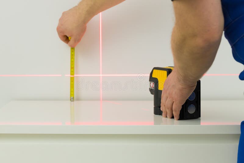 A Specialist Makes Measurements Using an Electronic Laser Measuring the ...