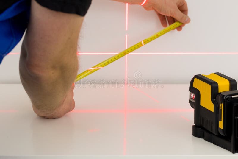 A Specialist Makes Measurements Using an Electronic Laser Measuring the ...