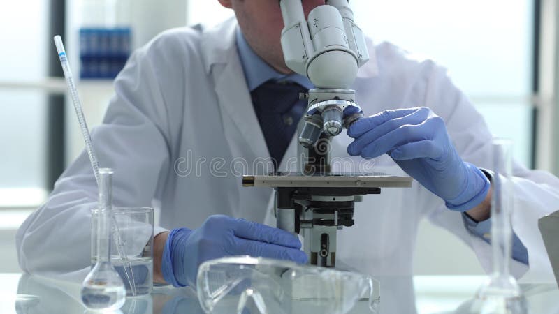 Close Up. the Scientist Looks through the Microscope Stock Footage ...