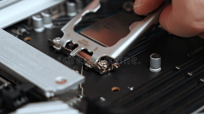 A Specialist Unscrews a Securing a Socket on a Motherboard Using a ...