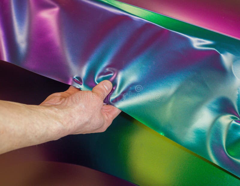 A Specialist in Wrapping a Car with Chameleon-colored Vinyl Film in the ...