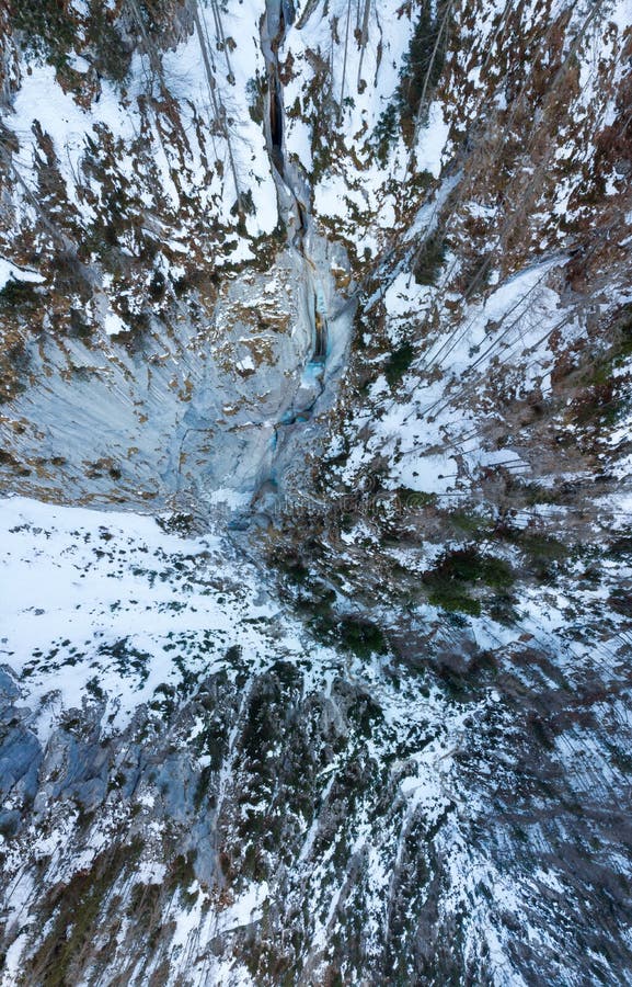 Spectacular Drop Down View of Waterfall Falling Over Rocky Forest Ledge ...