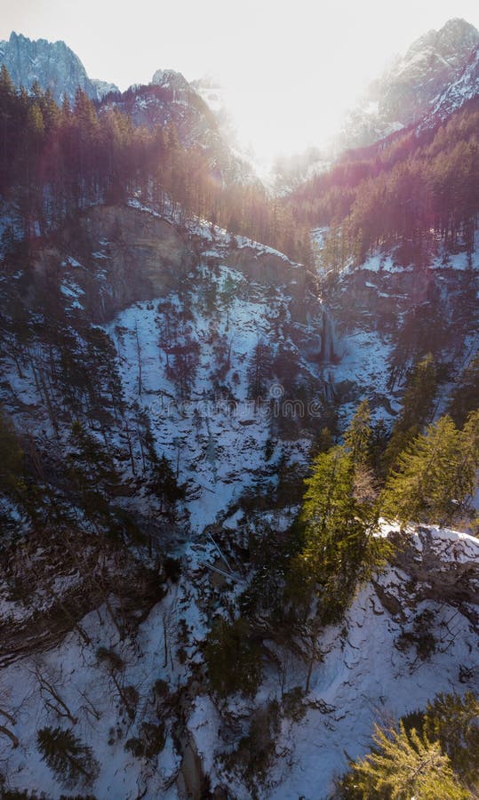 Spectacular Drop Down View of Waterfall Falling Over Rocky Forest Ledge ...