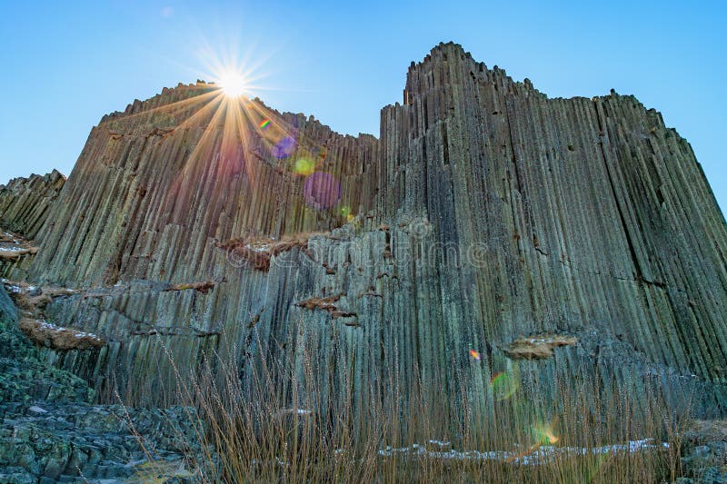 Spectacular Sunlit Columnar Basalt Cliffs with Clear Blue Sky Stock ...