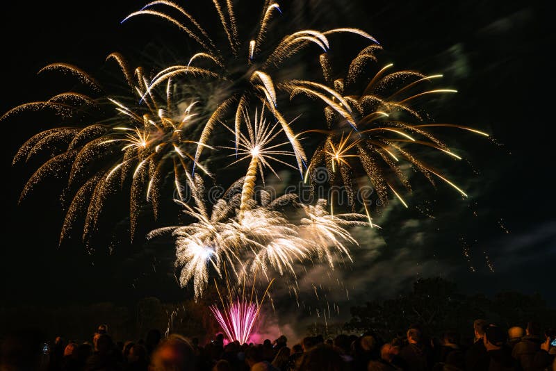 Spectacular View of a Crowd Watching Beautiful Fireworks Explode in a ...