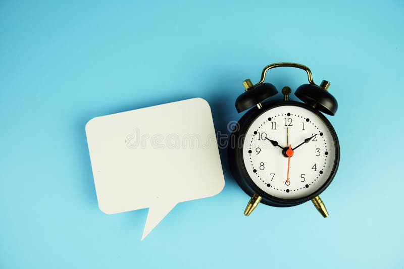 Speech Bubble and Alarm Clock on Blue Background Stock Photo - Image of ...