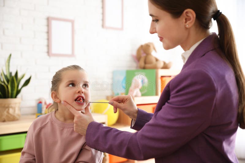 Speech Therapist Using Logopedic Probe on Session with Girl in Office ...